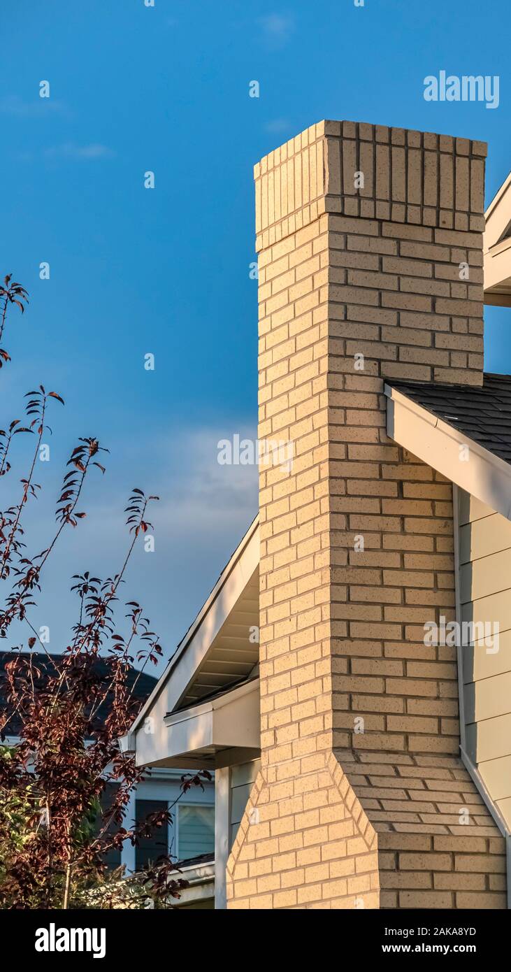 Vertical frame Feature brick chimney on a house exterior Stock Photo ...