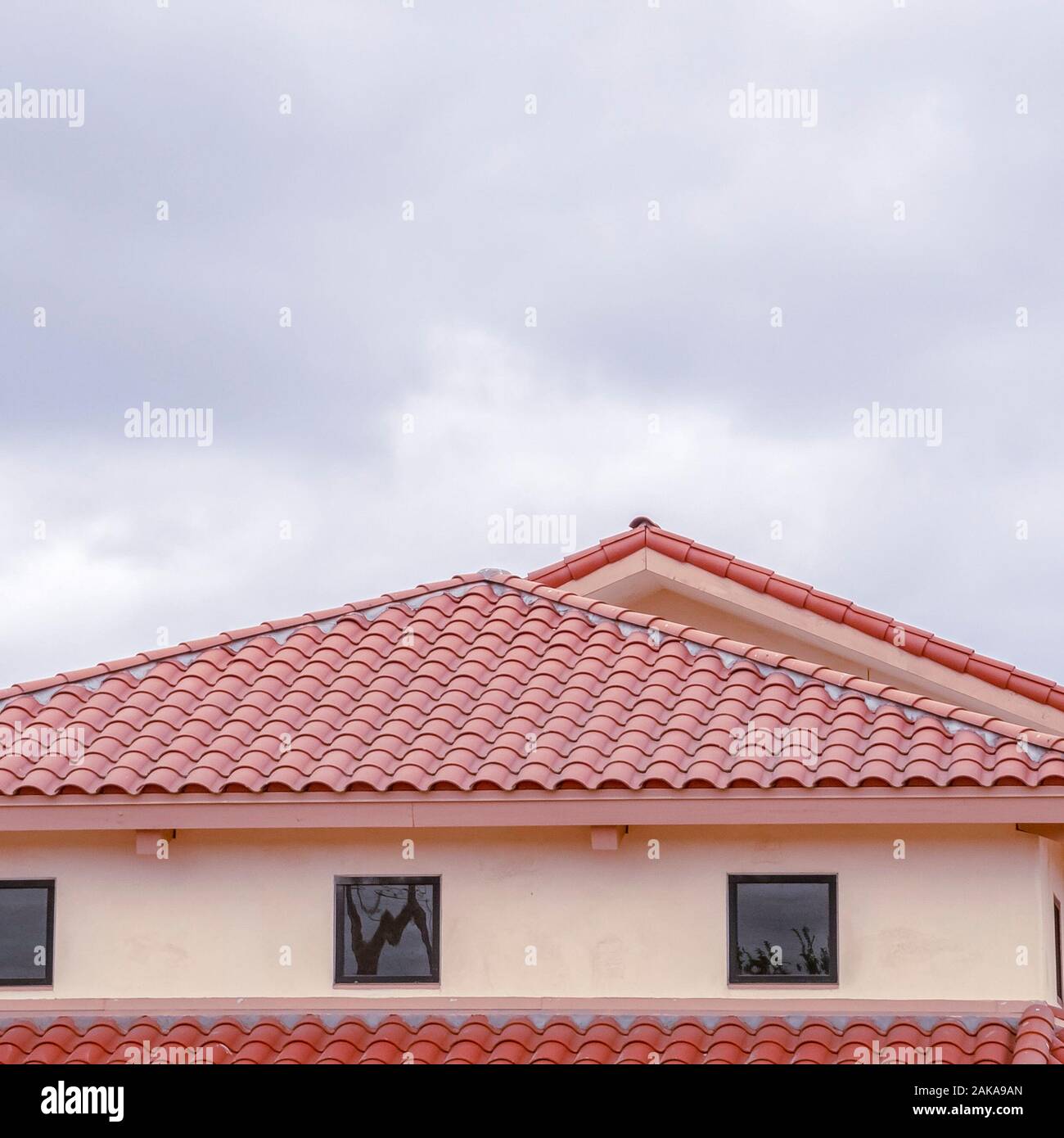 Square Tiled roof on a building with ventilation windows Stock Photo ...