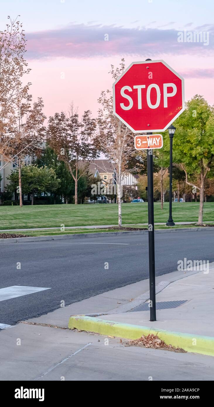 Vertical frame Stop sign at a street intersection at sunset Stock Photo ...