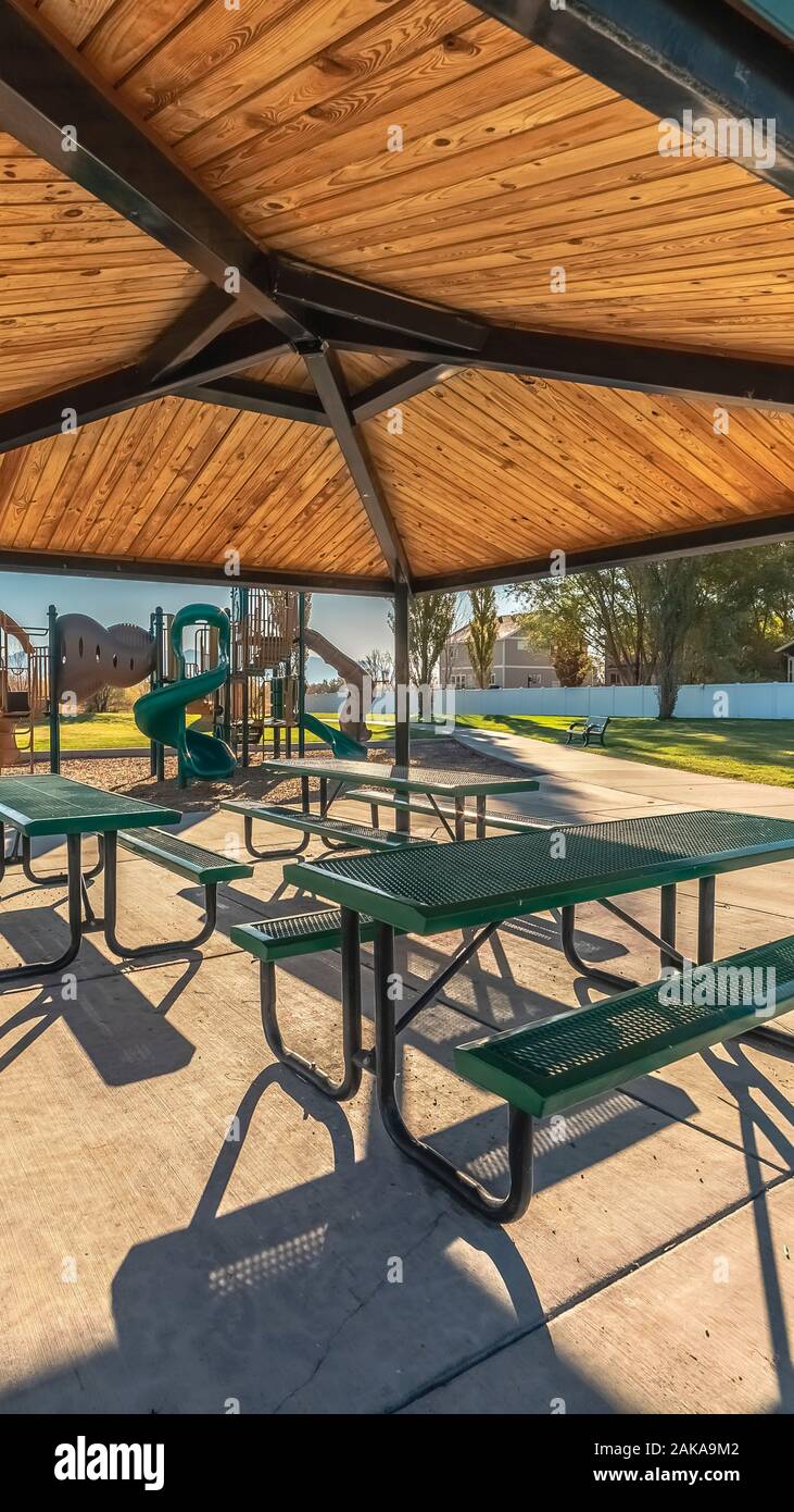 Vertical frame Covered picnic tables in a small urban park Stock Photo ...
