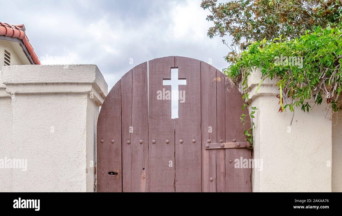 Panorama Entry gate to a church with a small white cross Stock Photo ...