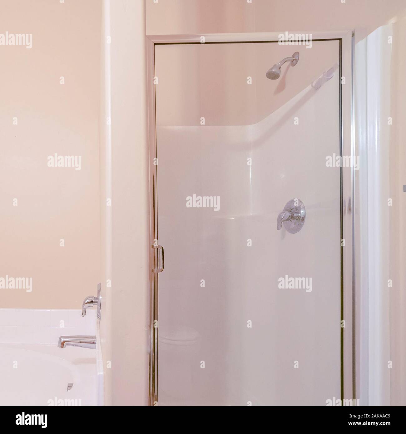 Square frame Shower cabin and bathtub in bathroom in home Stock Photo ...