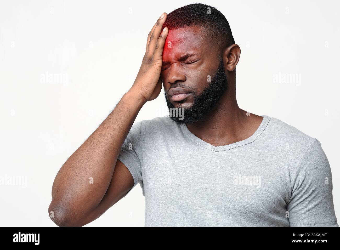 Young man suffering from terrible strong head pain, touching his ...