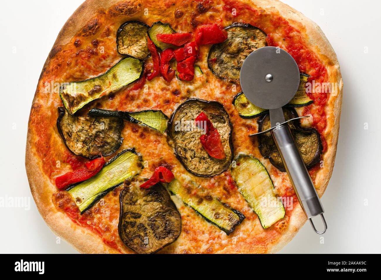 large italian pizza with grilled vegetables isolated on a white table ...