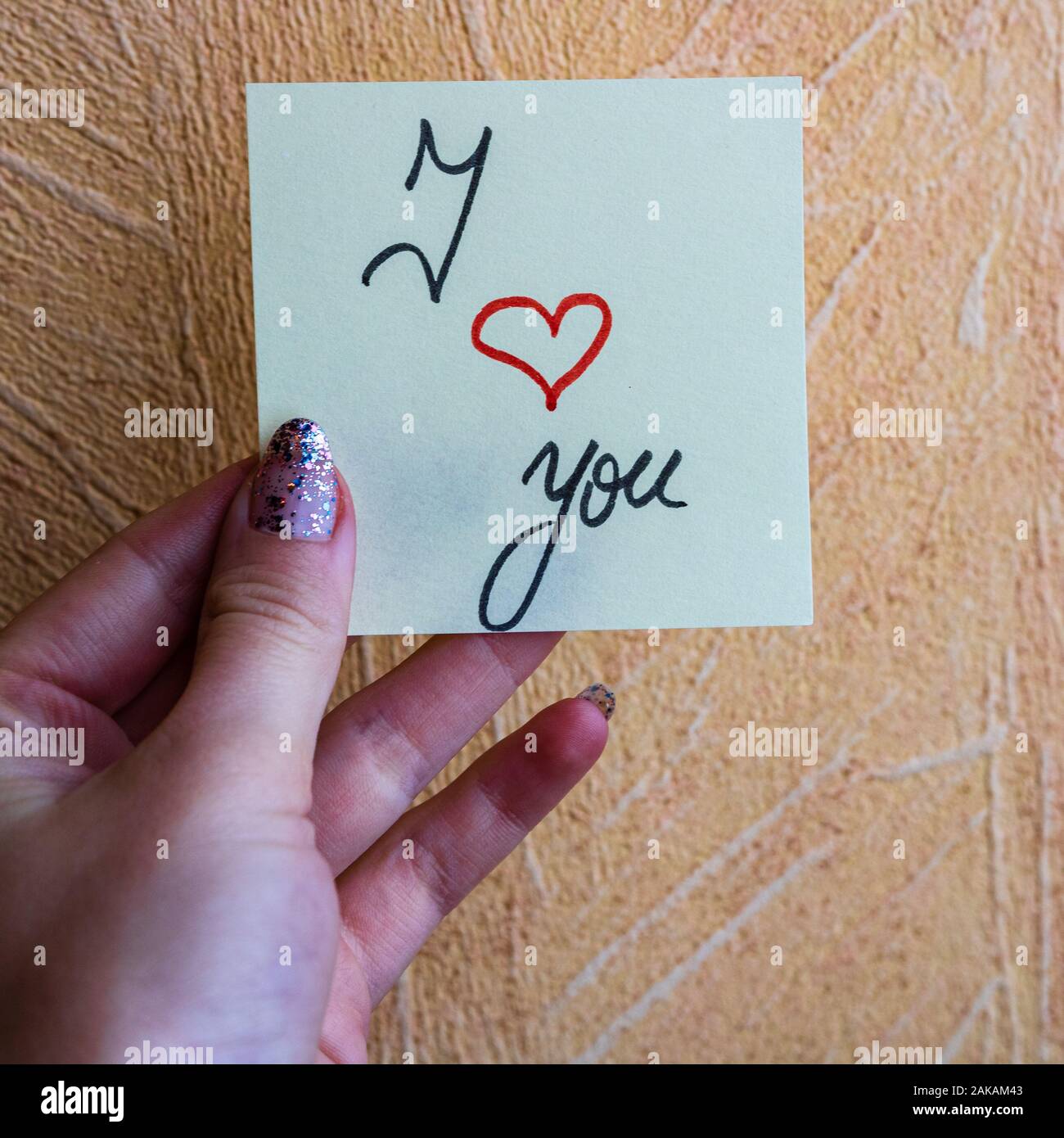 Text I love you on post it. Writing on colorful sticky note. Hand ...