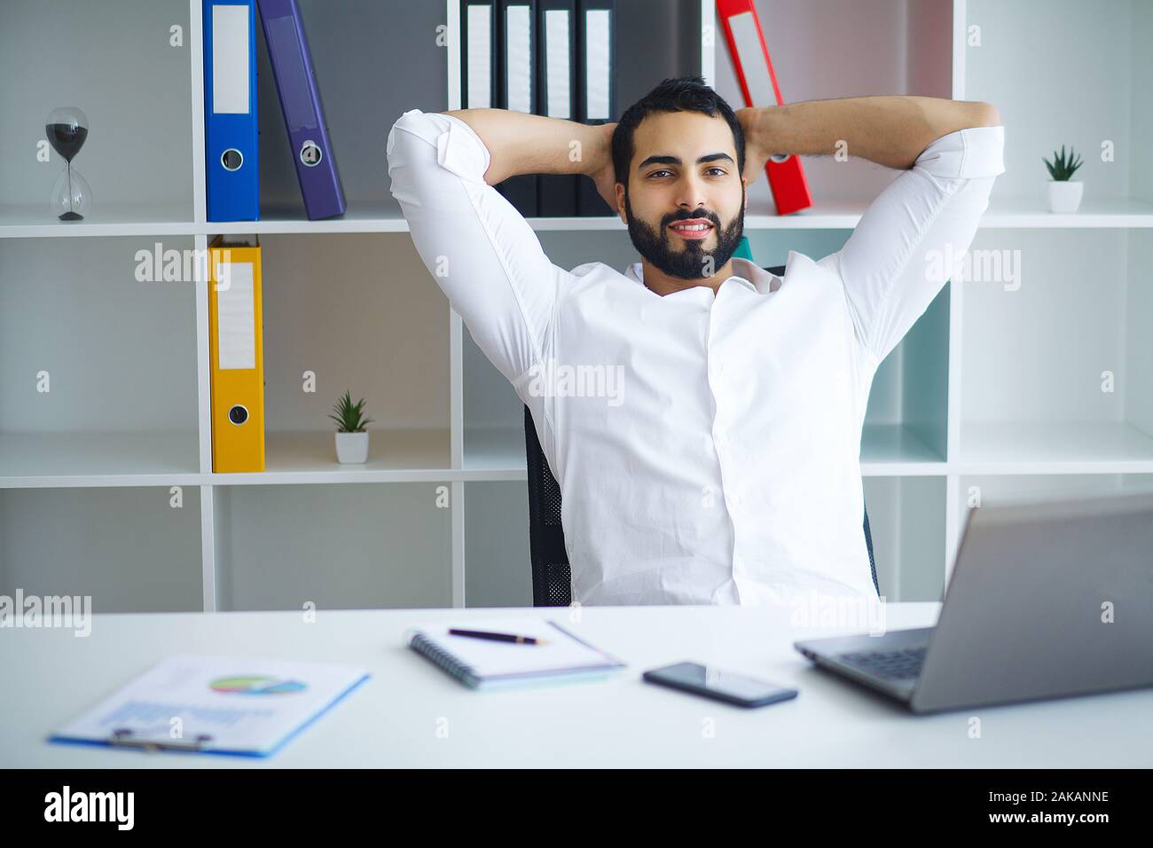 Handsome man working on project at modern office desk Stock Photo - Alamy