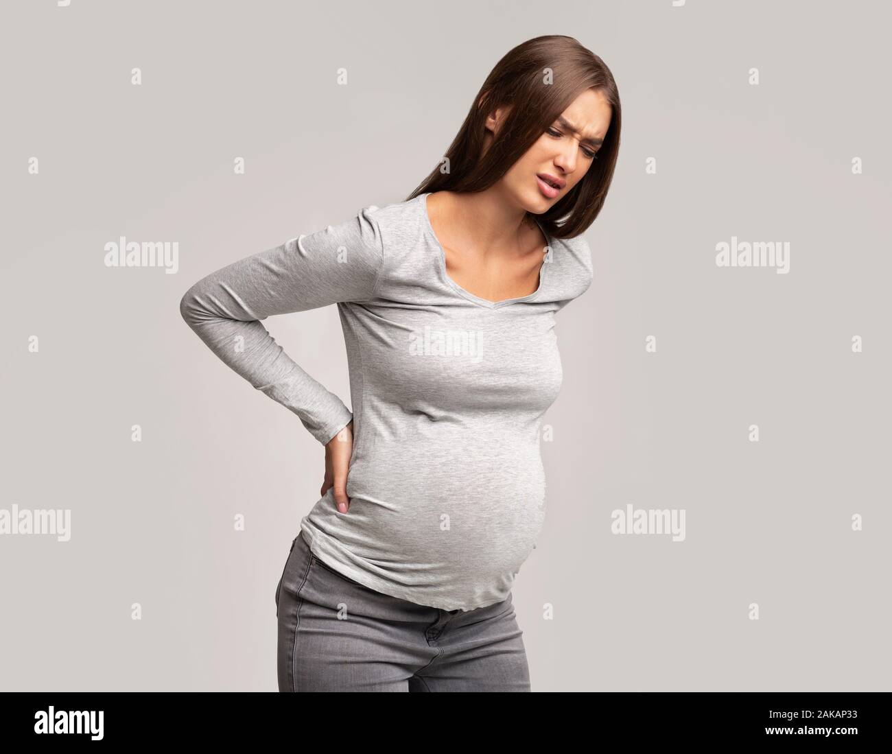 Pregnancy Backache. Pregnant Woman Having Lower Back Pain Standing Over ...