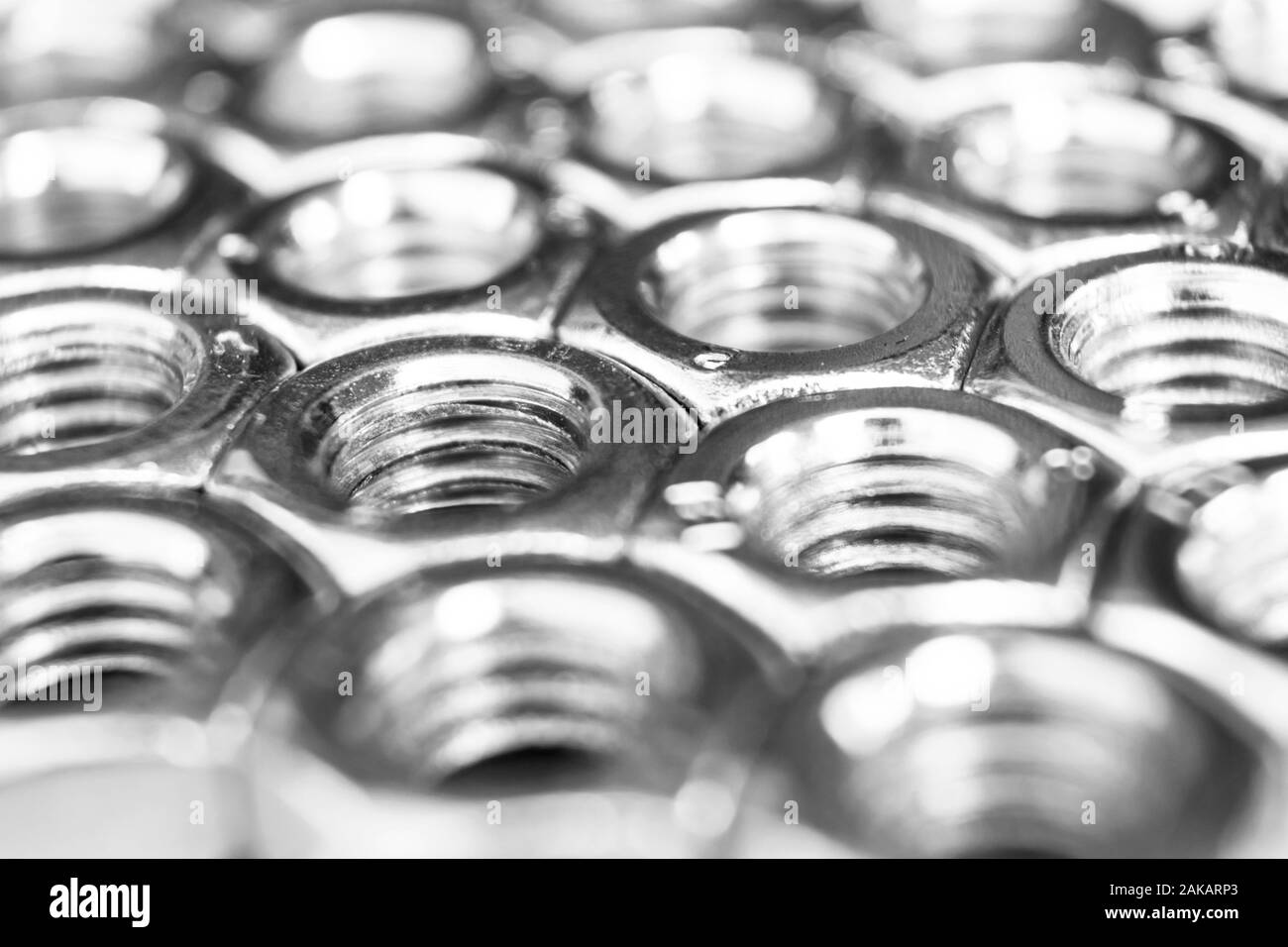 Metal nuts in a row background. Chromed screw nuts isolated. Steel nuts ...