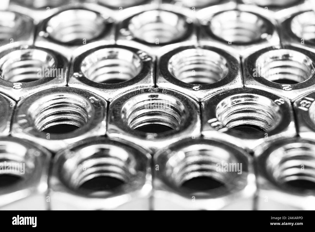 Metal nuts in a row background. Chromed screw nuts isolated. Steel nuts ...