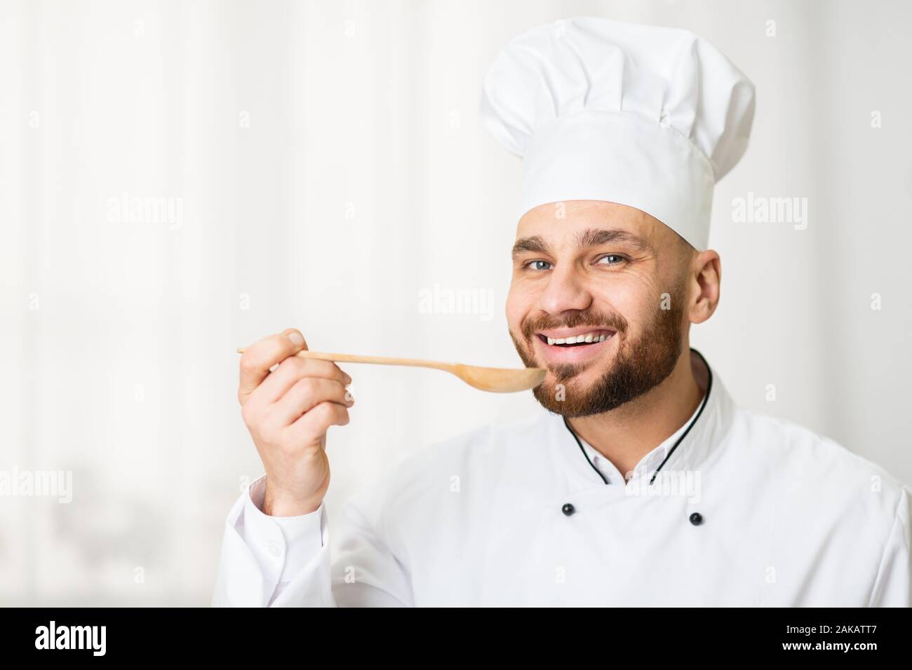 Happy Chef Man Tasting Food Holding Spoon Smiling At Camera Standing ...