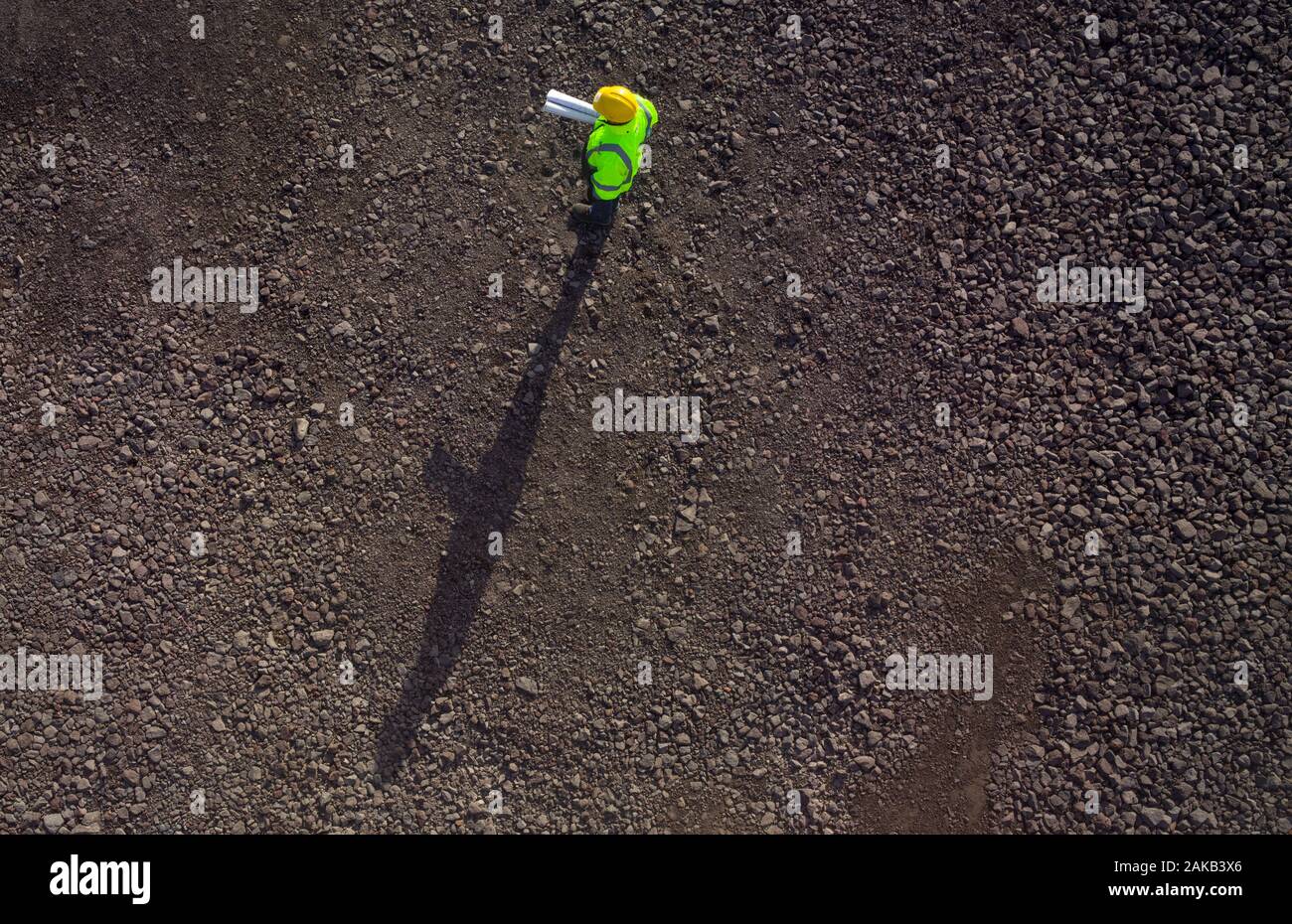 Birds eye view of a construction worker on gravel Stock Photo - Alamy