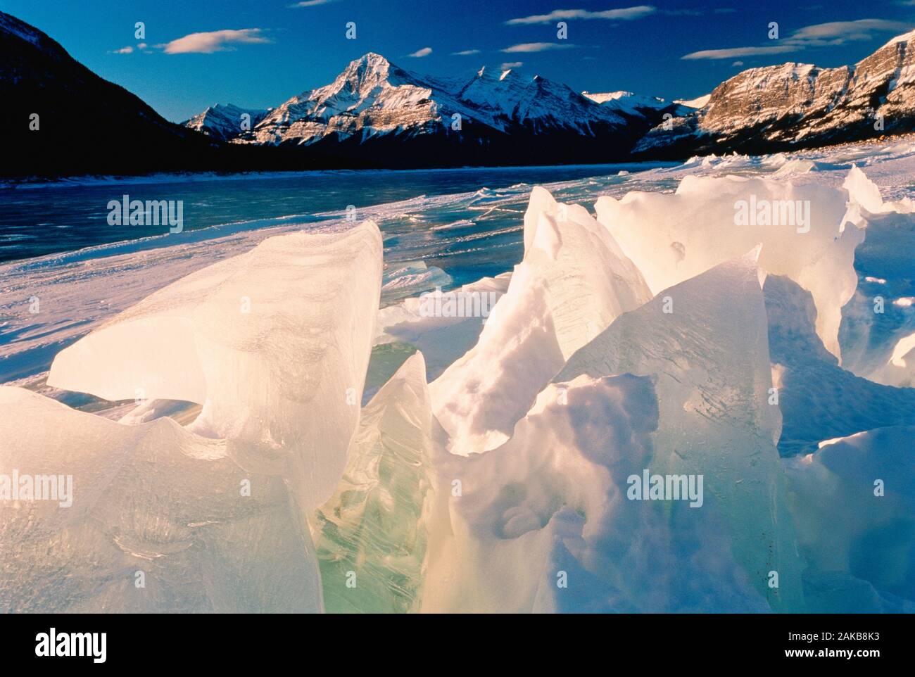 Landscape with ice in frozen Abraham lake and Canadian Rocky Mountains ...