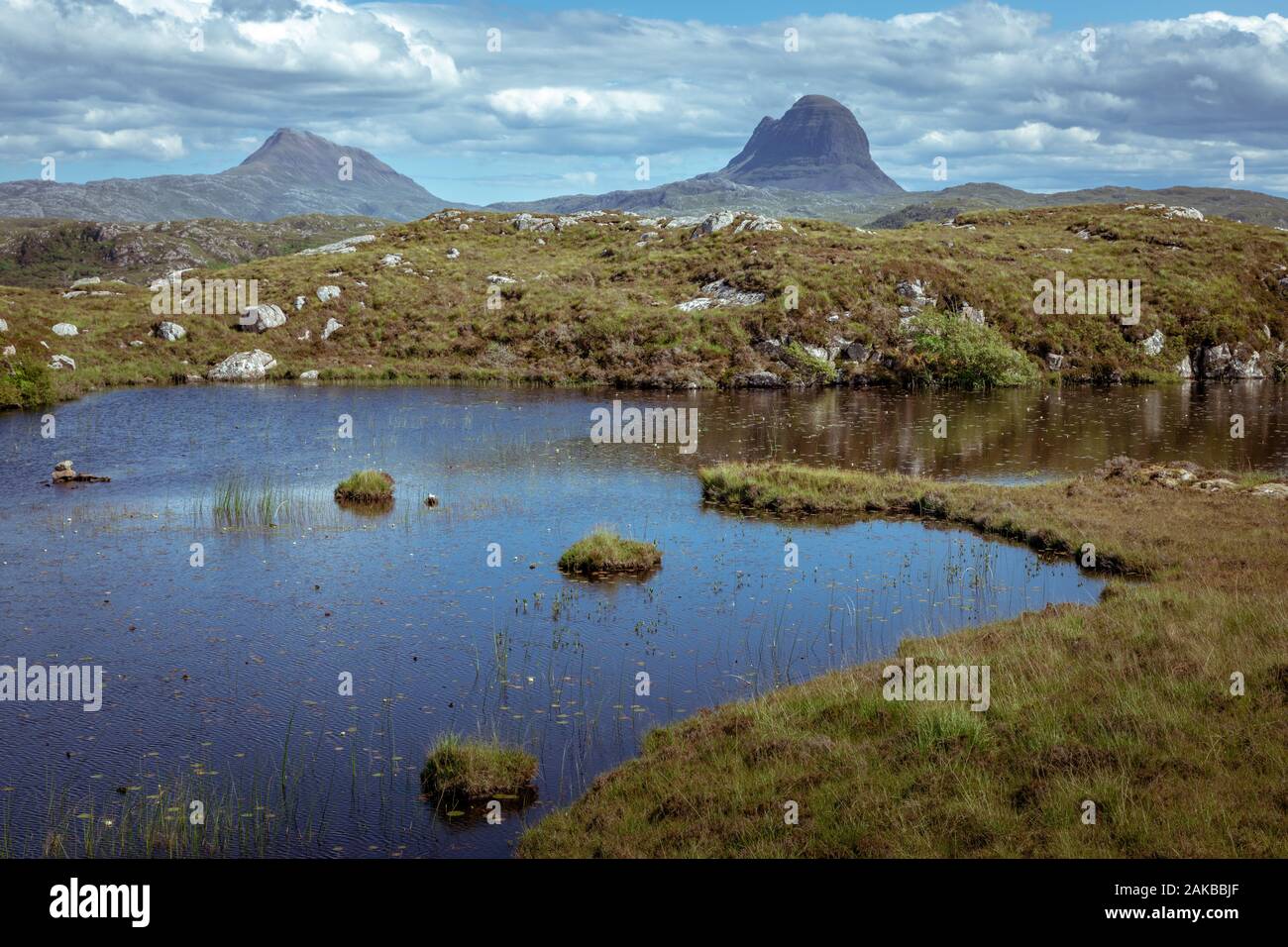 The lochan of Loch an Tuim with the mountains of Canisp and Suilven in ...