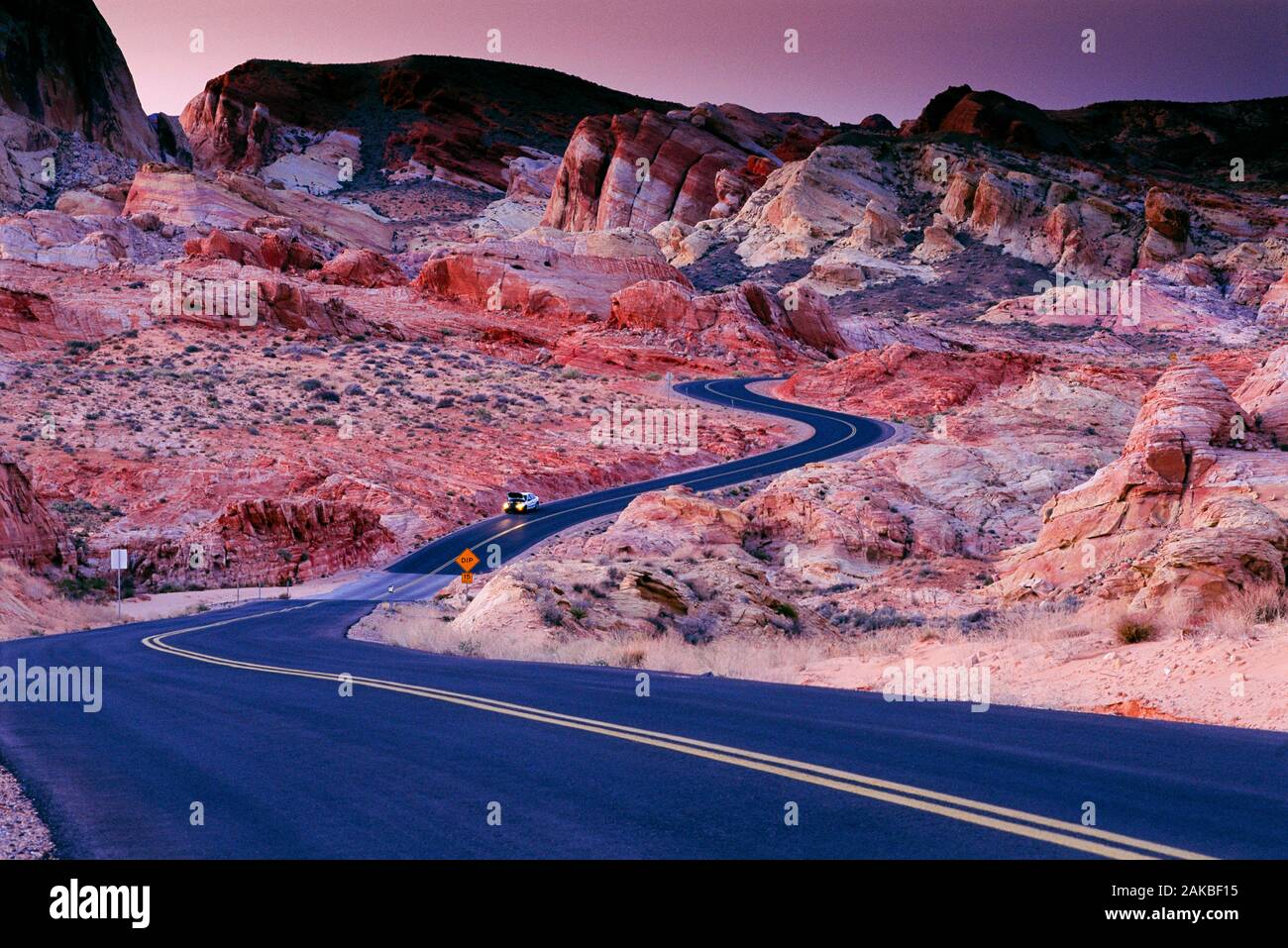 Car on desert highway at dusk, Nevada, USA Stock Photo - Alamy
