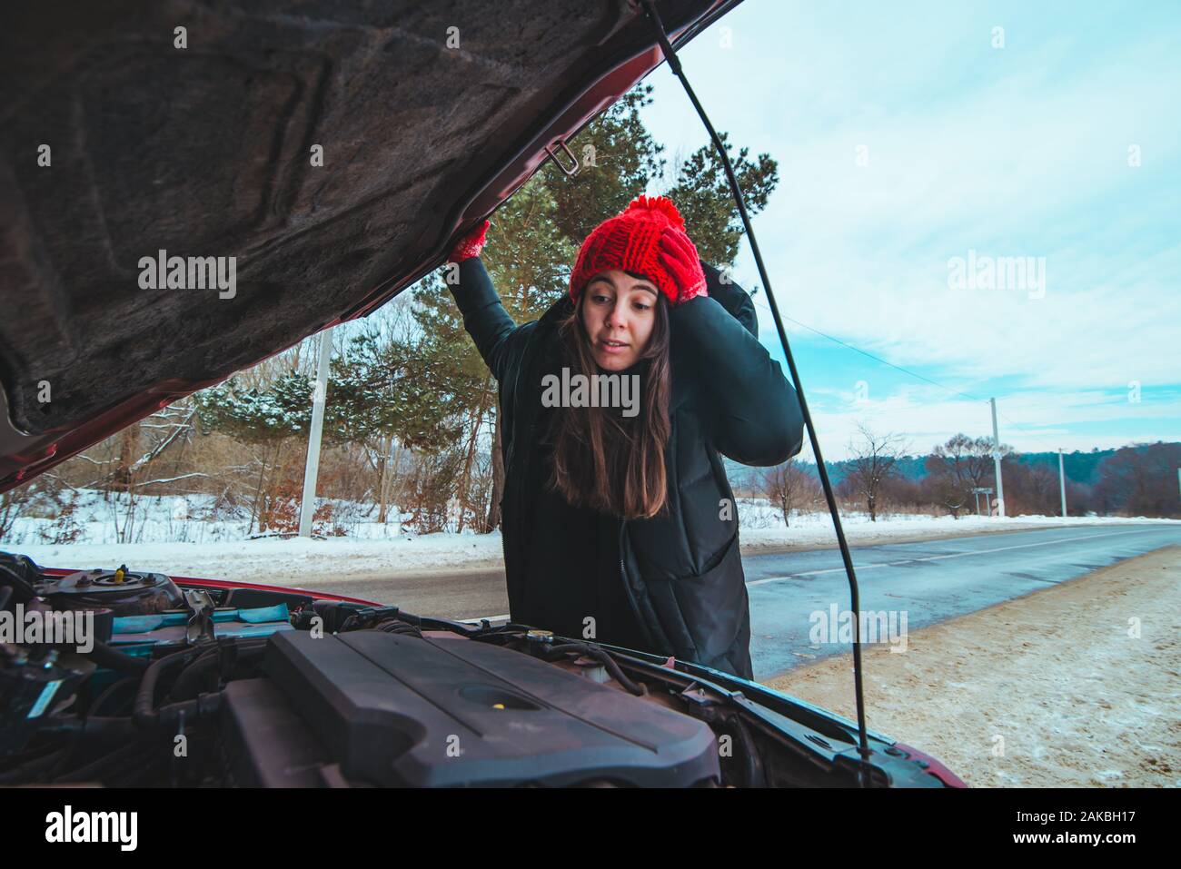 woman looking at car engine road assistance Stock Photo - Alamy
