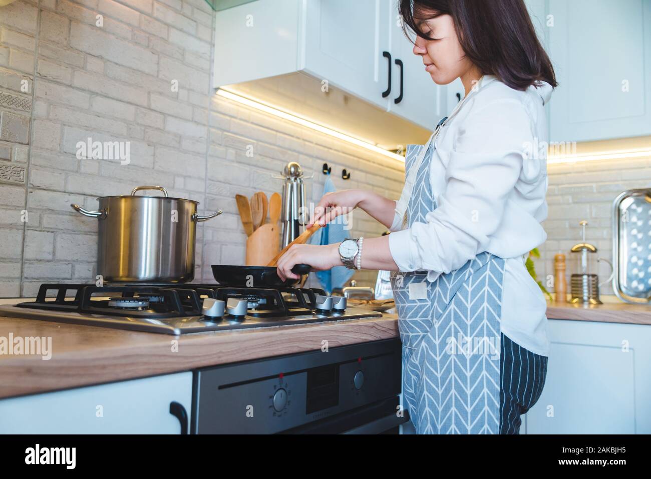 Back view woman cooking in hi-res stock photography and images - Alamy
