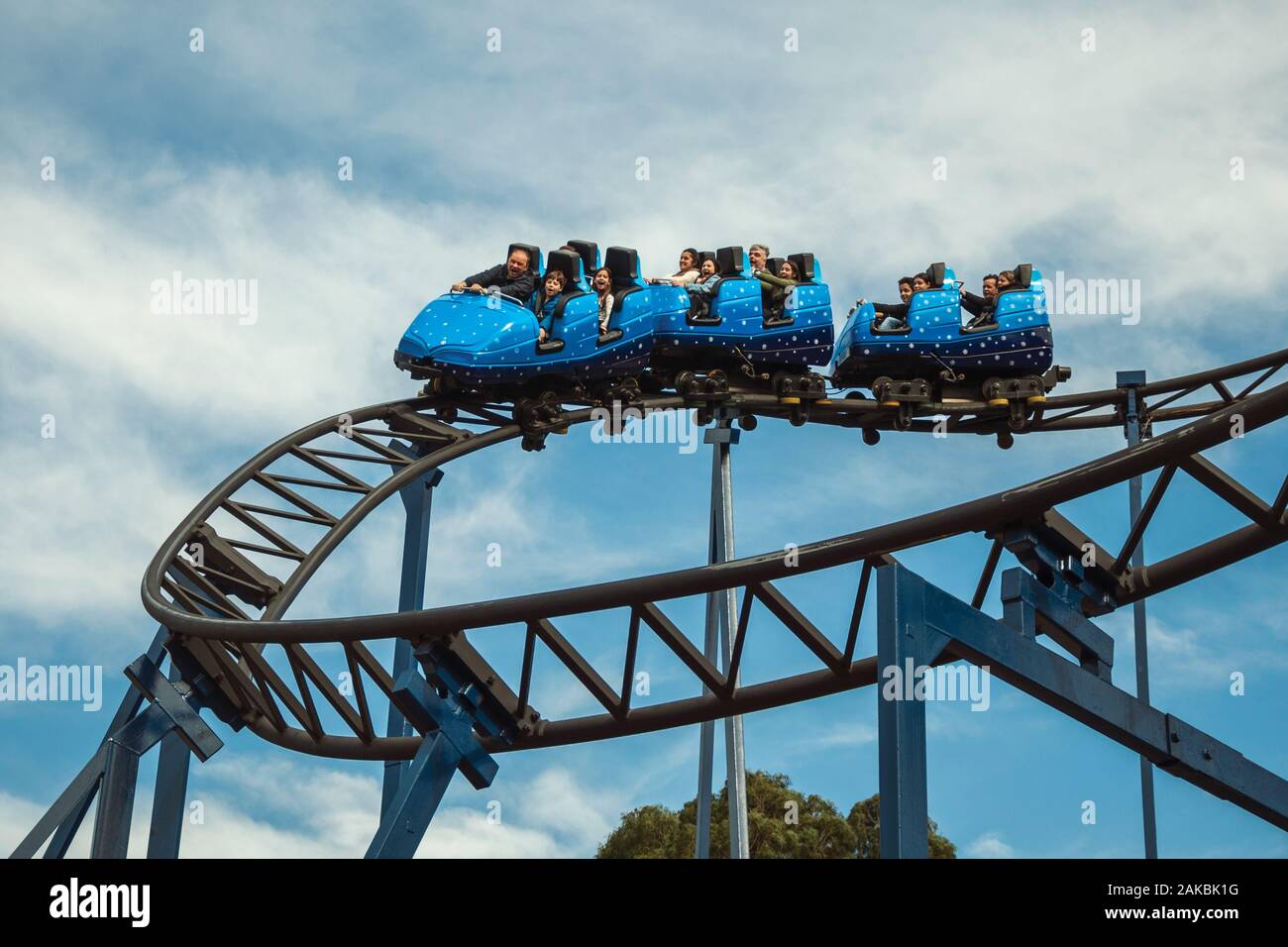 People in a blue cart having fun on roller coaster at the Alpen ...