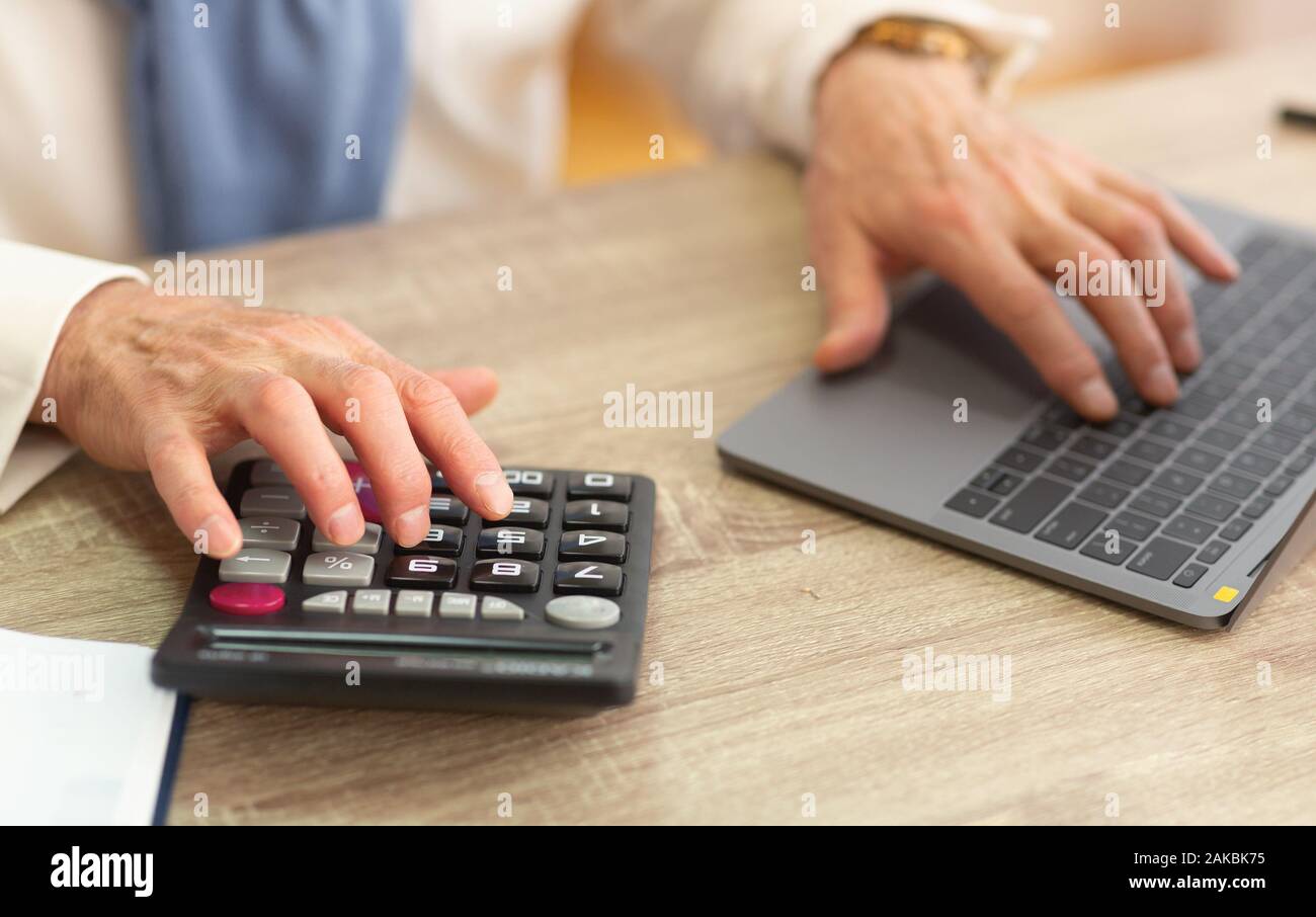 Technology Evolution. Closeup Of Old Man's Hands Using Calculator And ...