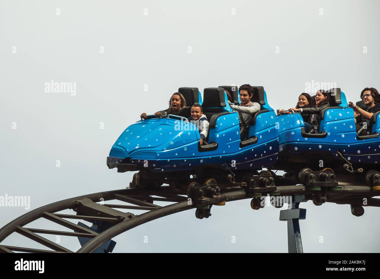 People in a blue cart having fun on roller coaster at the Alpen ...