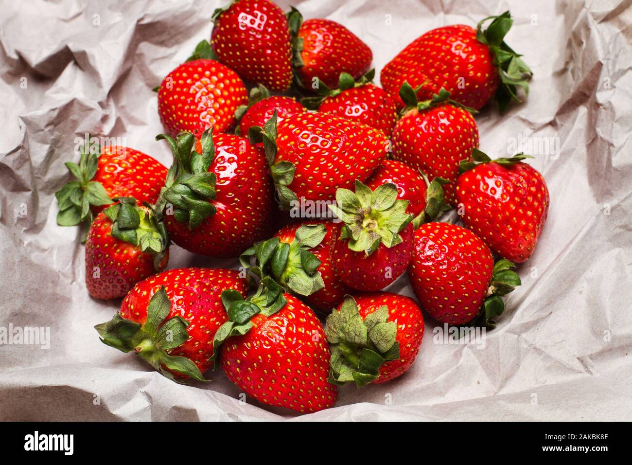 Delicious red strawberries on a gray wrinkled paper Stock Photo - Alamy