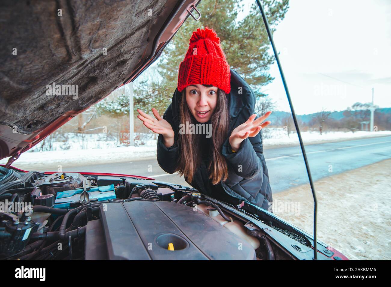 woman looking at car engine road assistance Stock Photo - Alamy