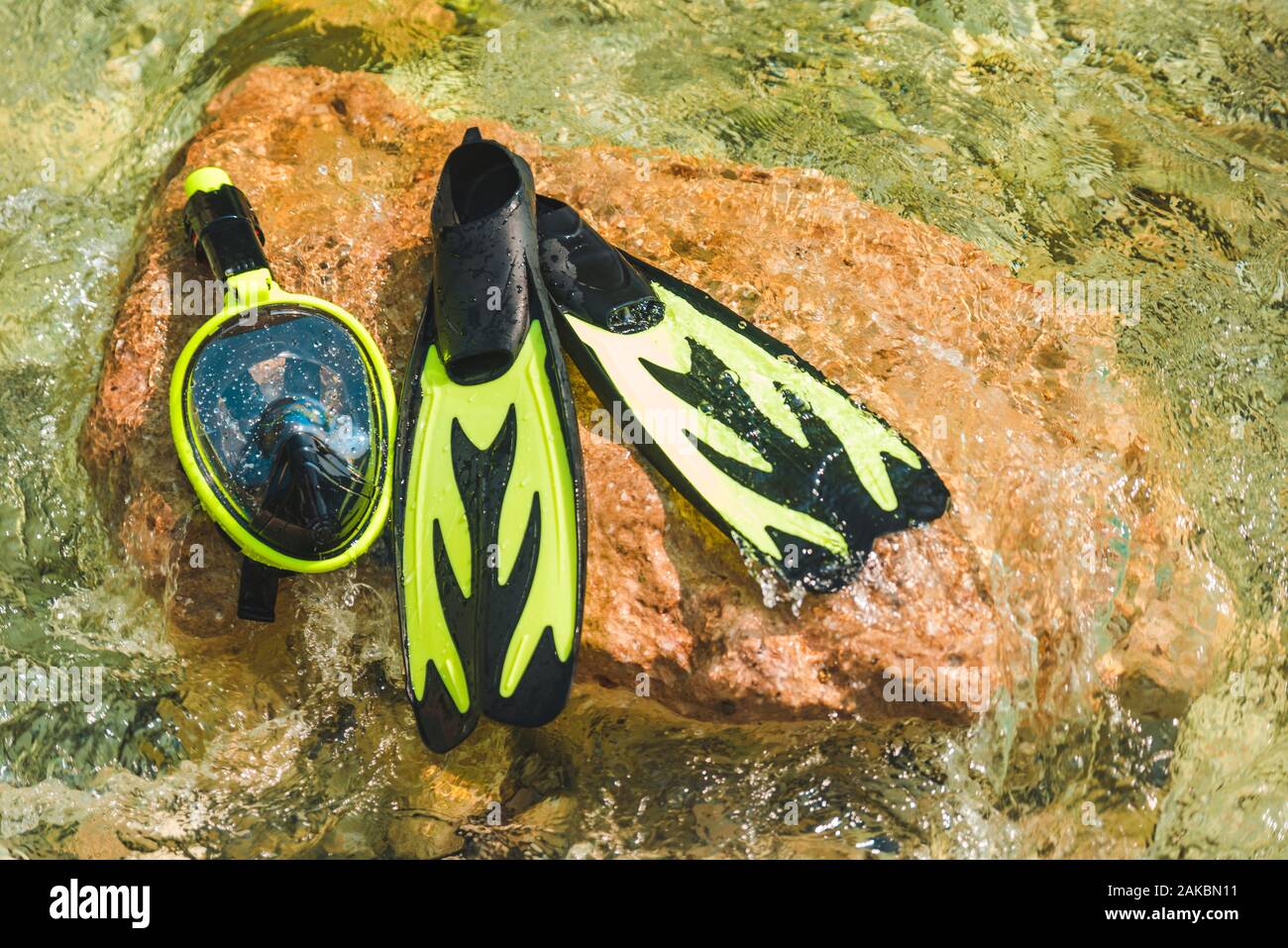 snorkeling mask with flippers at rock in sea water Stock Photo - Alamy