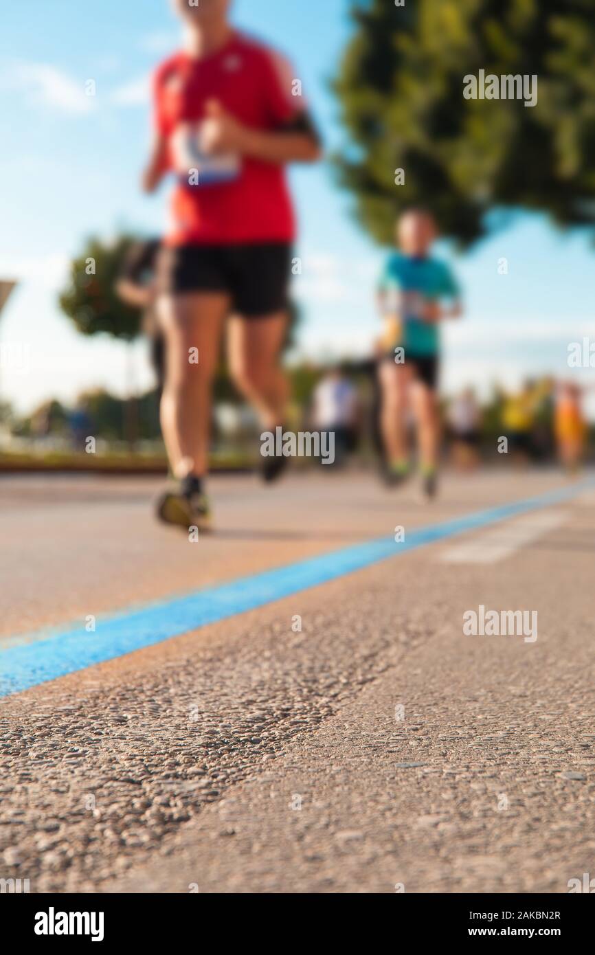 Marathon runners running at public city marathon. Marathon runners and ...