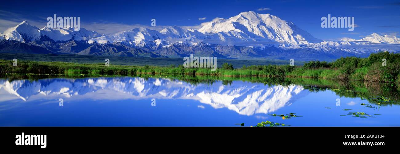 View of mountain range behind lake, Alaska Range, Denali National Park ...