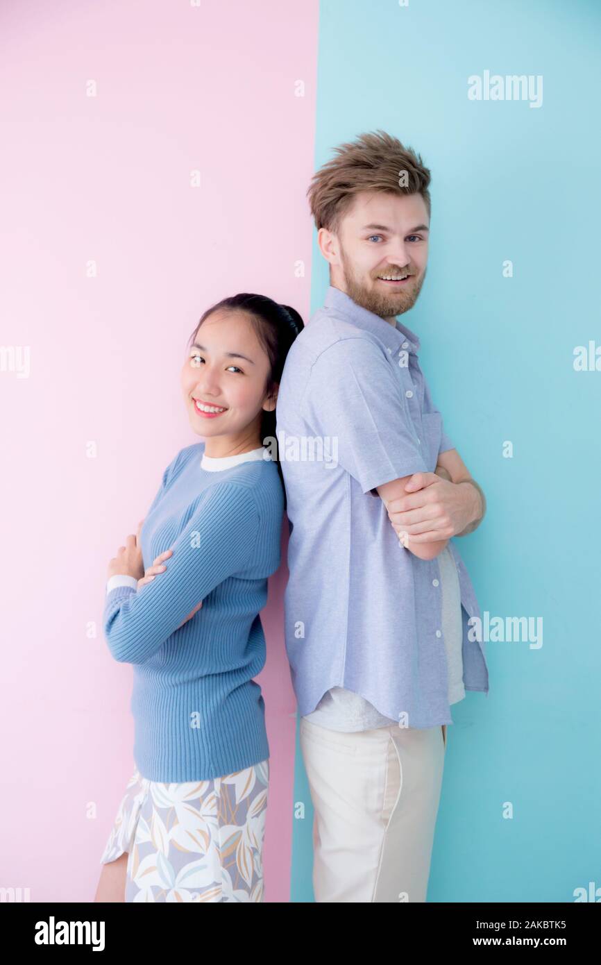 Portrait of a happy couple together standing retro color background ...