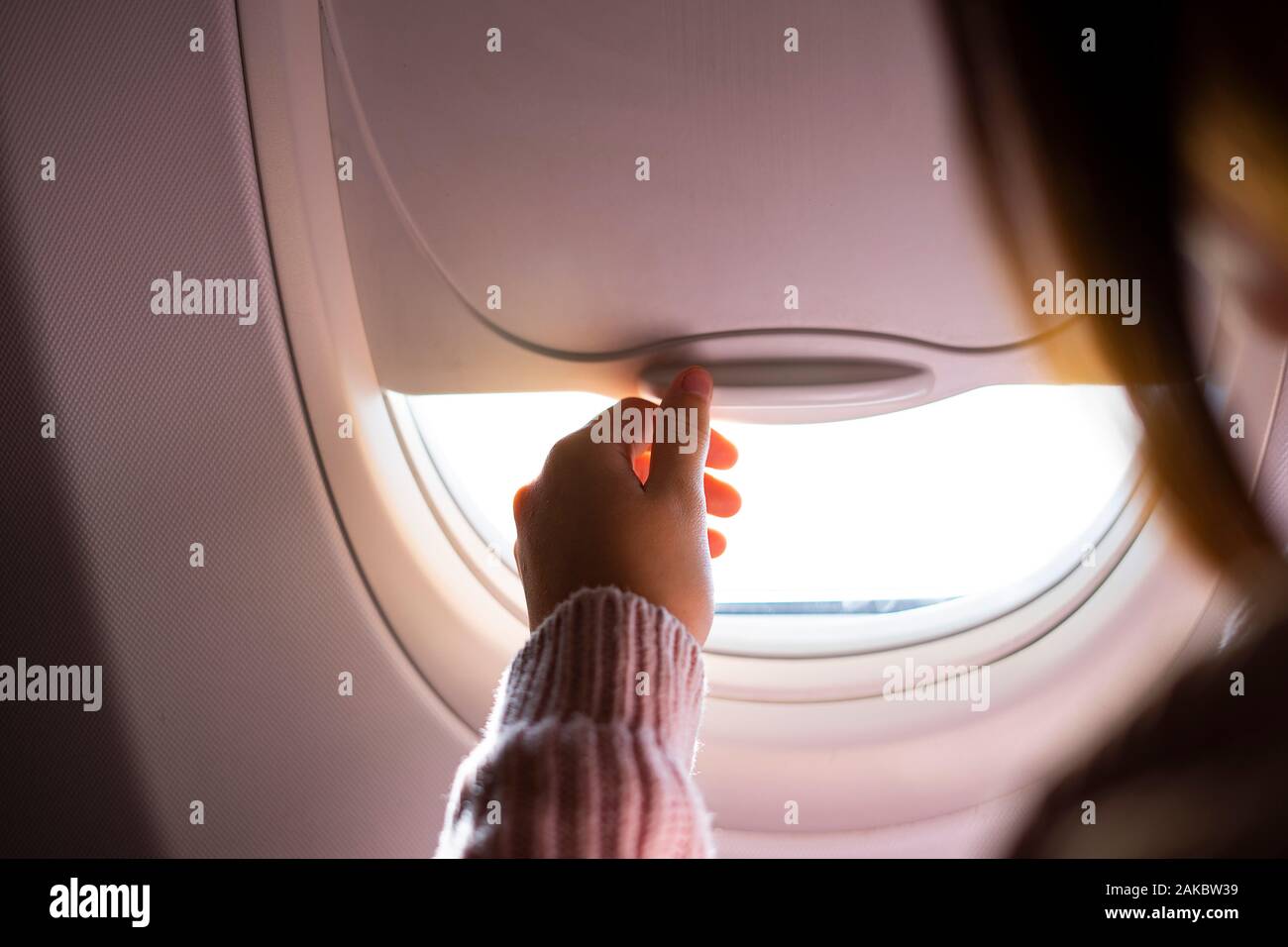 Woman's hand opening a plane window. Concept of air travel and ...