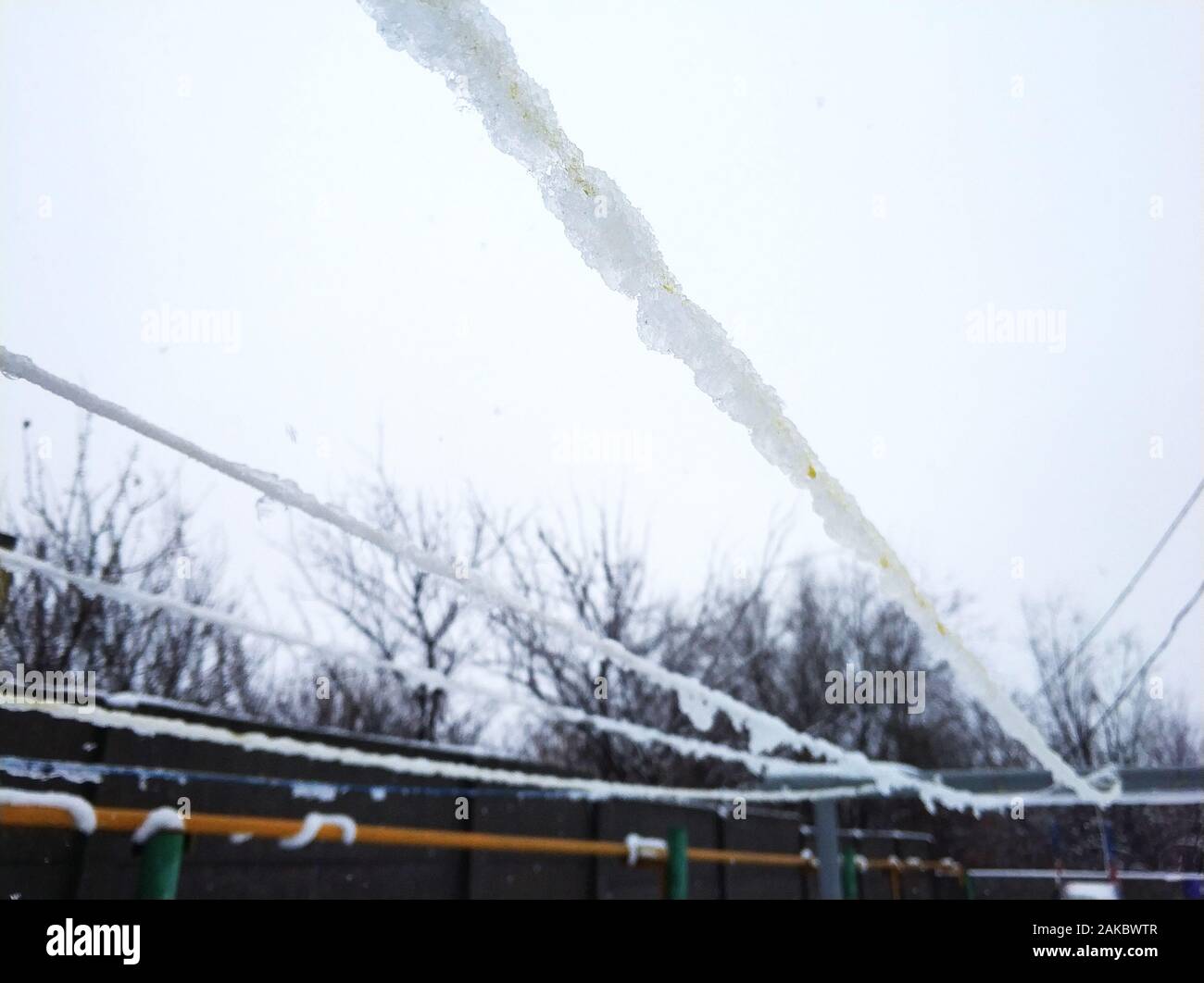 An iced rope for drying clothes. Drying clothes in winter Stock Photo ...