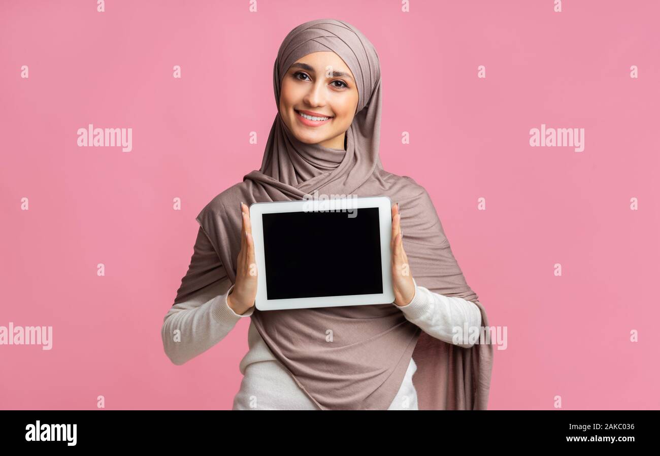 Happy Islamic Girl Holding Digital Tablet With Black Screen And Looking ...