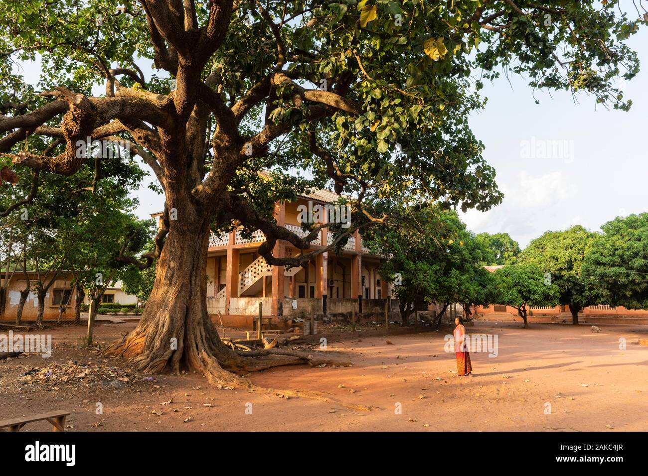 Benin, Abomey, woman standing in front of a colonial structure Stock ...
