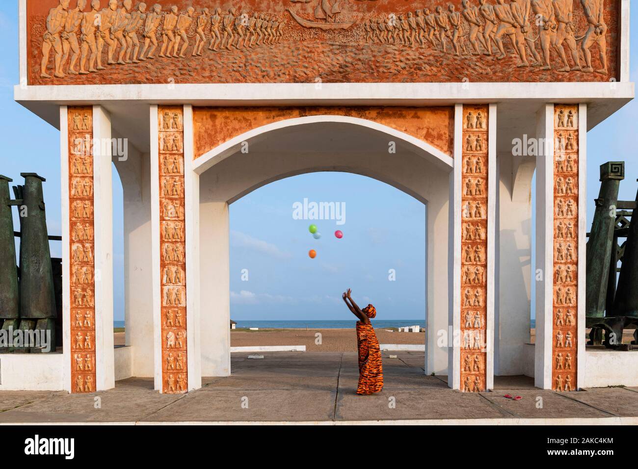 Benin, Ouidah, woman releasing balloons as a sign of freedom, under the ...
