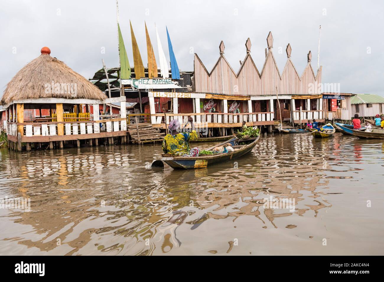 Benin, lakeside city of Ganvié, woman going to the market with her ...