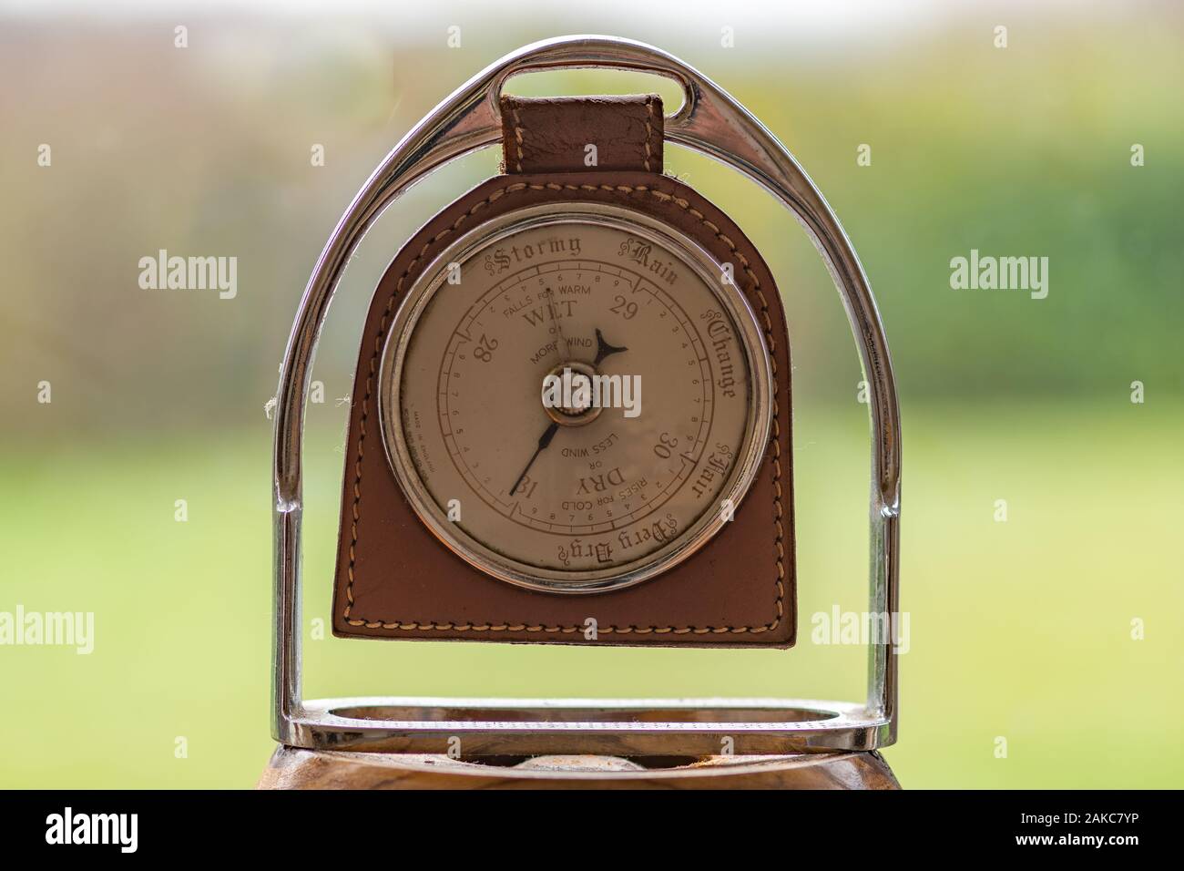 Close up of an old antique barometer made out of an old horses stirrup ...