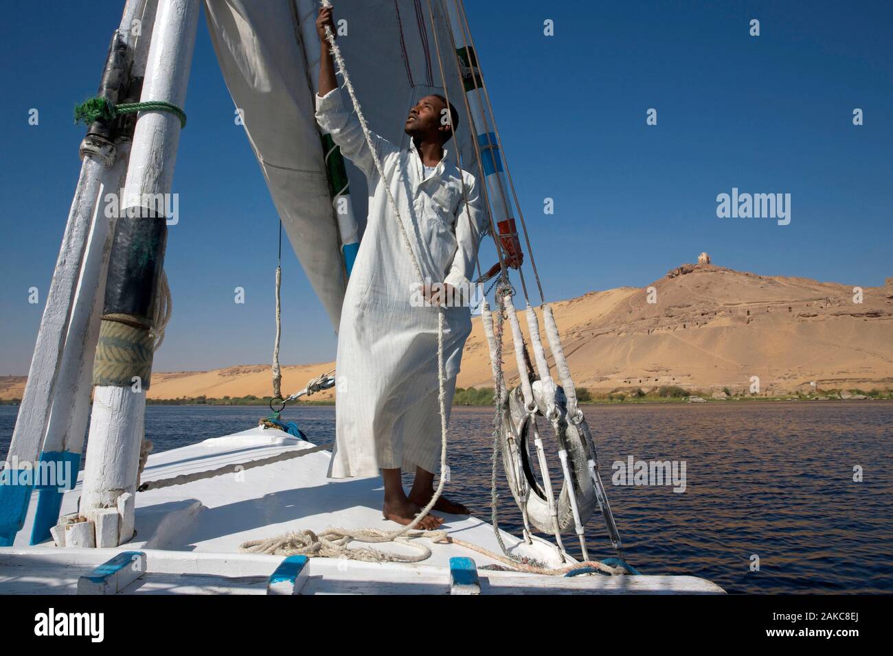 Egypt, Upper Egypt, Aswan, Nubian sailor in front of his felucca all ...