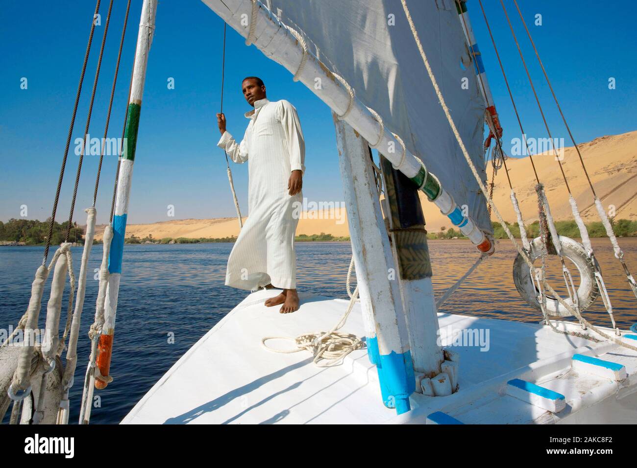 Egypt, Upper Egypt, Aswan, Nubian sailor in front of his felucca all ...