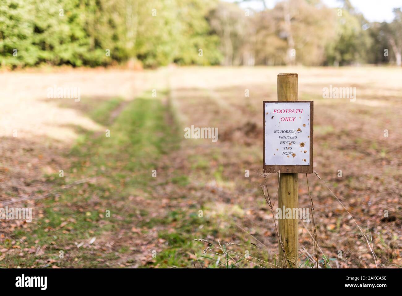 A rural signpost explaining that no vehicles or horses are allowed past ...