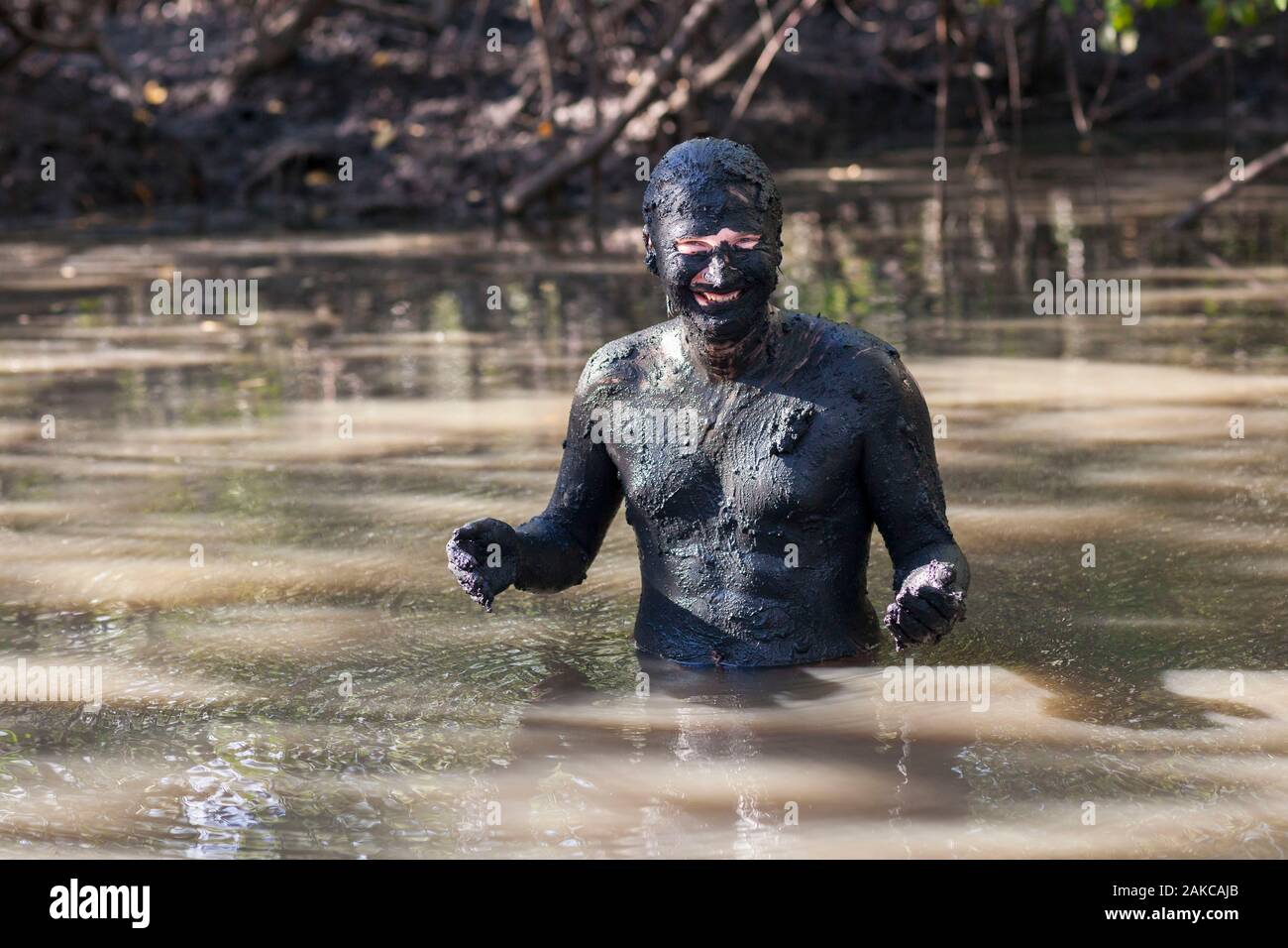 Brazil, Bahia state, Porto Seguro, shirtless man, smiling, covered with ...