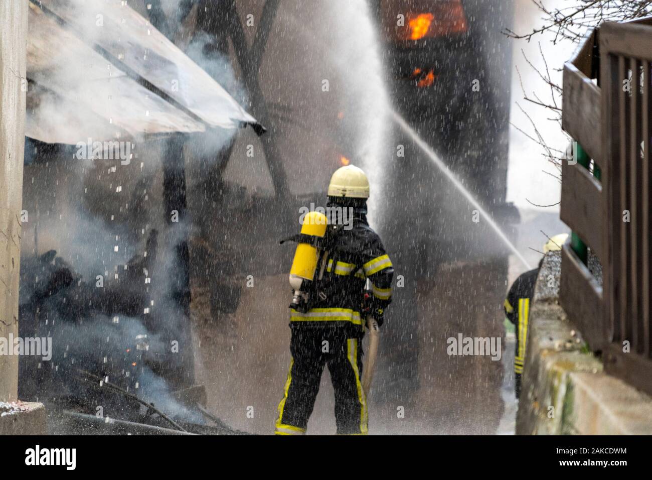 firemen fighting a fire in wood house Stock Photo - Alamy