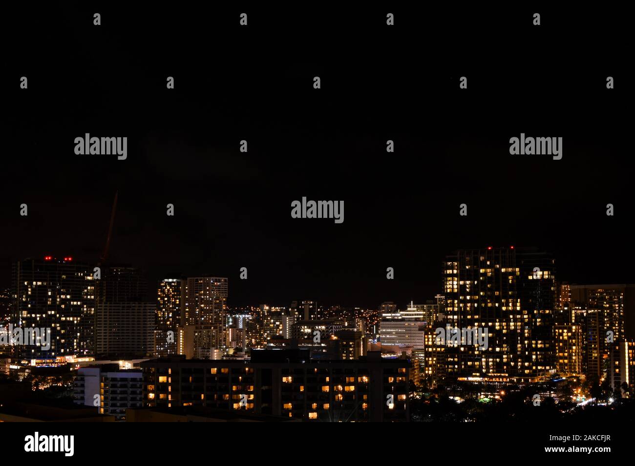 Honolulu Cityscape at Night showing lit buildings and a dark sky Stock ...