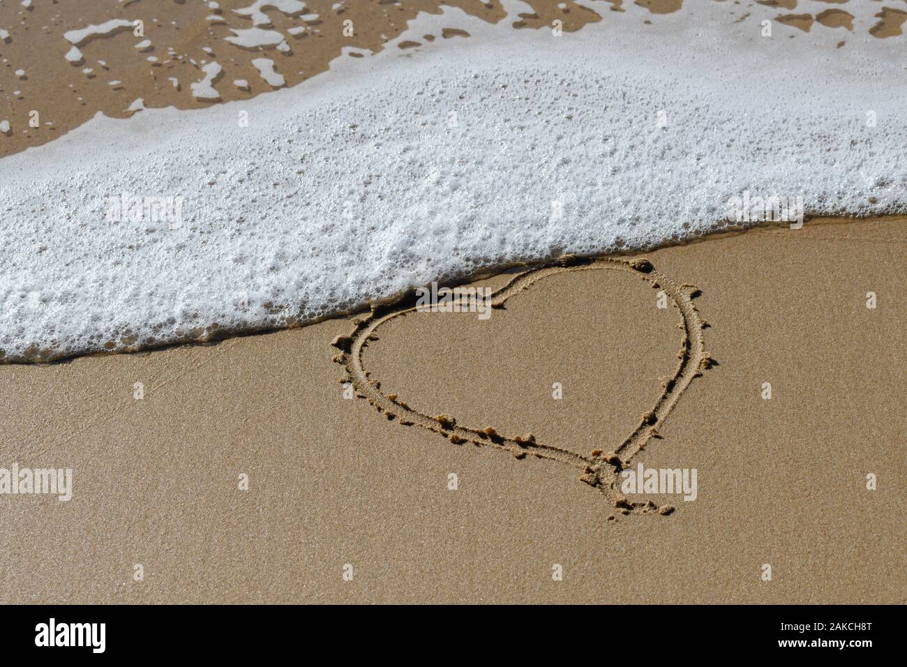 Heart shape drawn in sand at the beach Stock Photo - Alamy