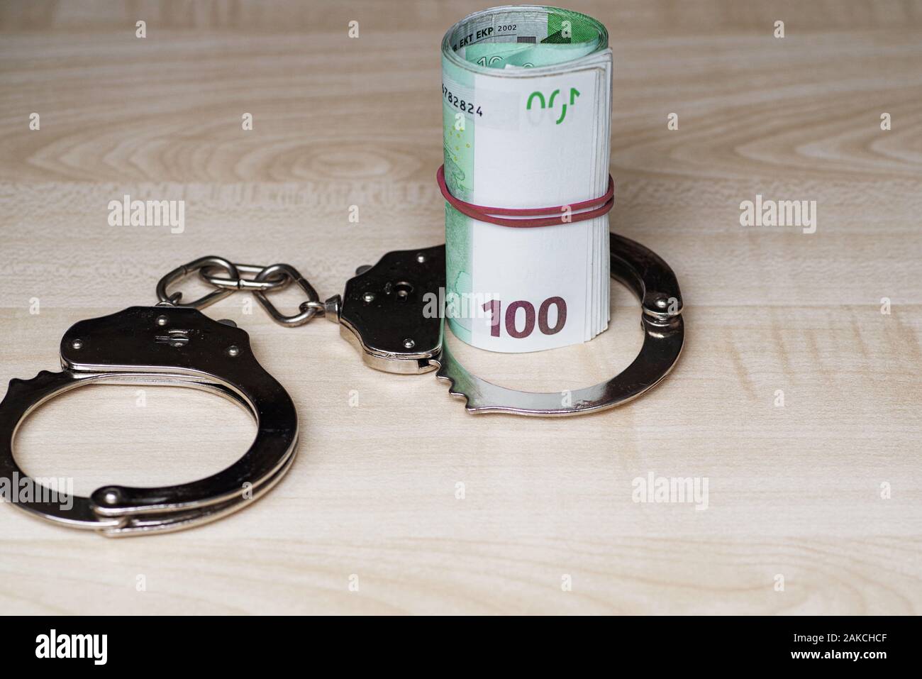 The concept of corruption. Money and handcuffs. Punishment for a bribe ...