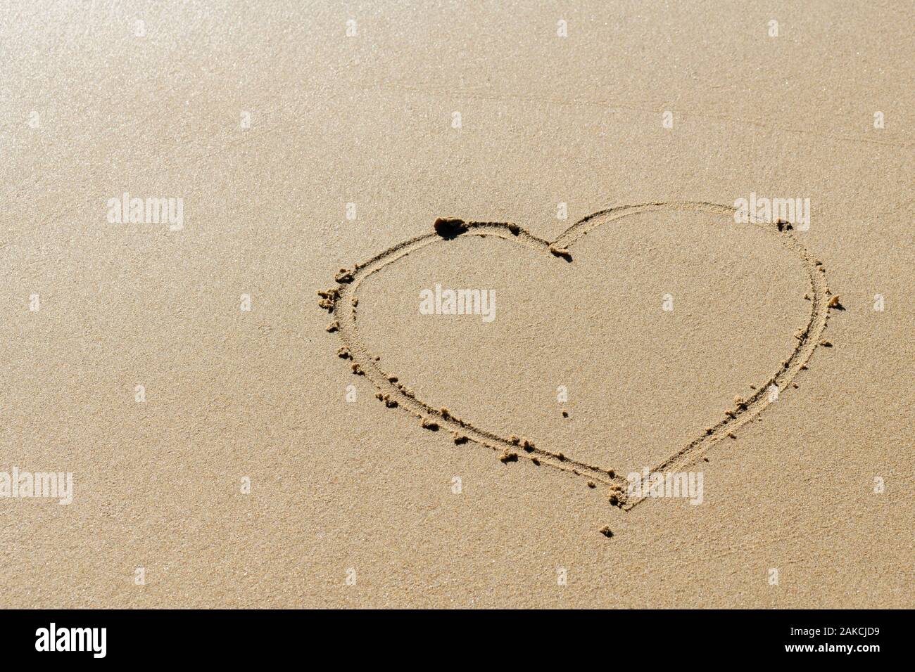 Heart shape drawn in sand at the beach Stock Photo - Alamy