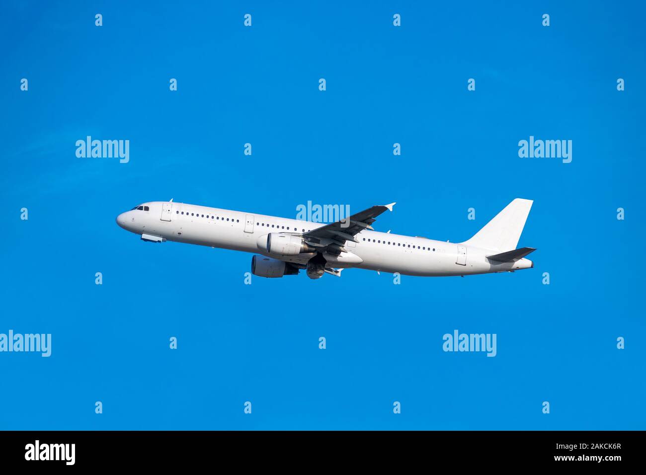 Passenger plane is taking off into the blue sky side view Stock Photo ...