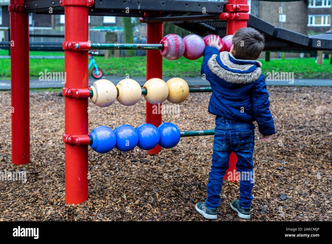 A small boy playing with a giant abacus in a park Stock Photo - Alamy