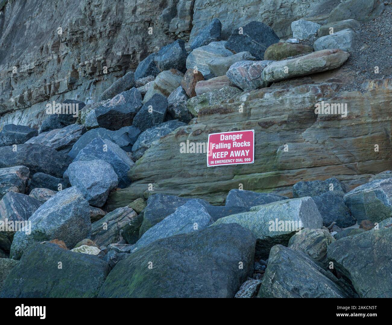 Danger warning signs of falling rocks at Staithes, North Yorkshire ...