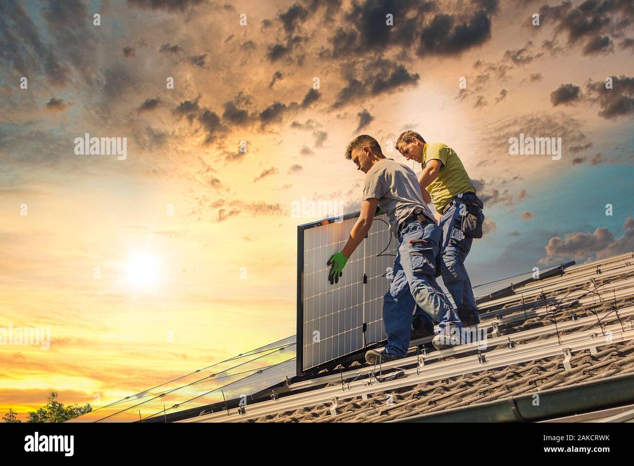 Installing solar photovoltaic panel system. Solar panel technician ...