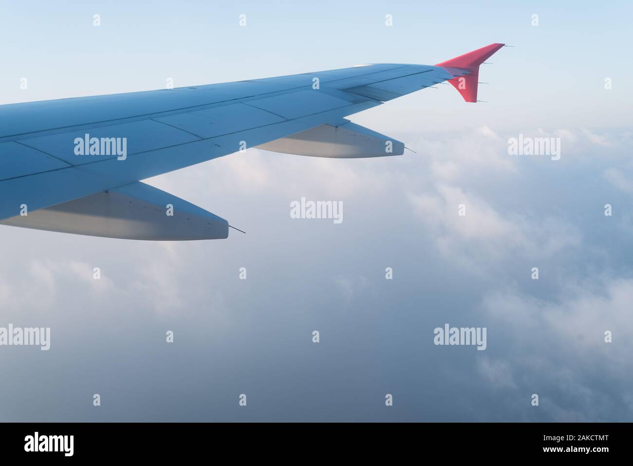View from the airplane window. Clouds under the wing Stock Photo - Alamy